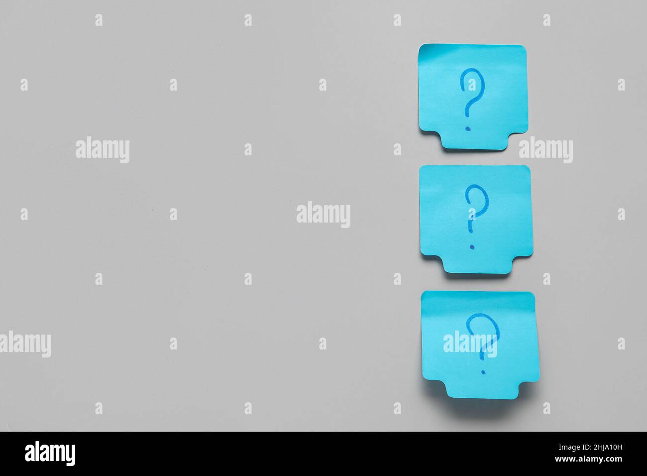 Sticky notes with question marks on grey background Stock Photo - Alamy