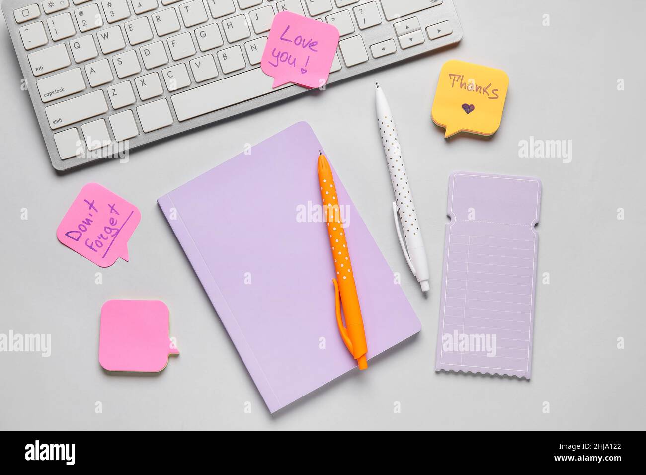 Stationery with different sticky notes and computer keyboard on light ...