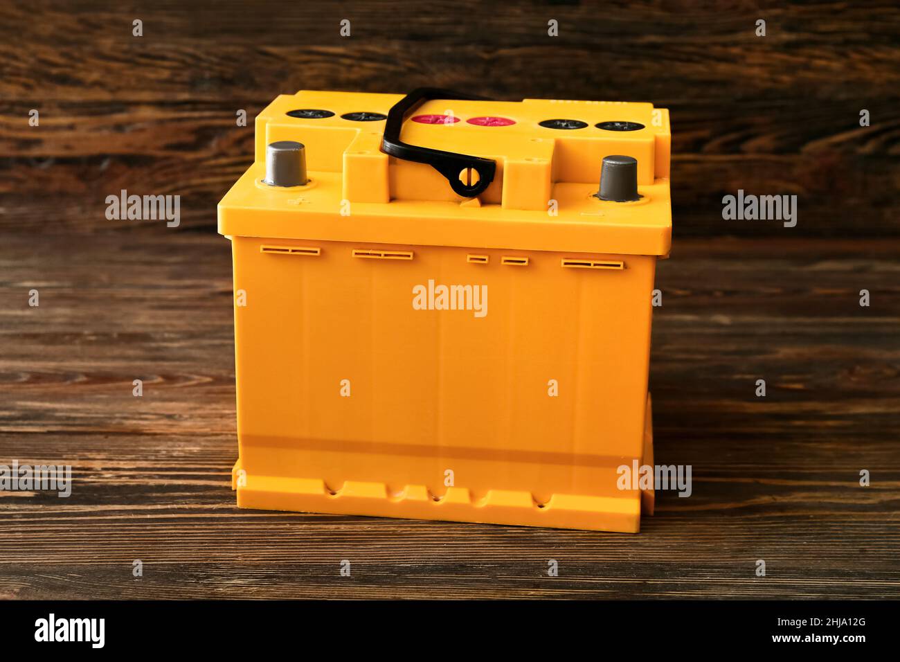 Modern car battery on wooden background Stock Photo - Alamy