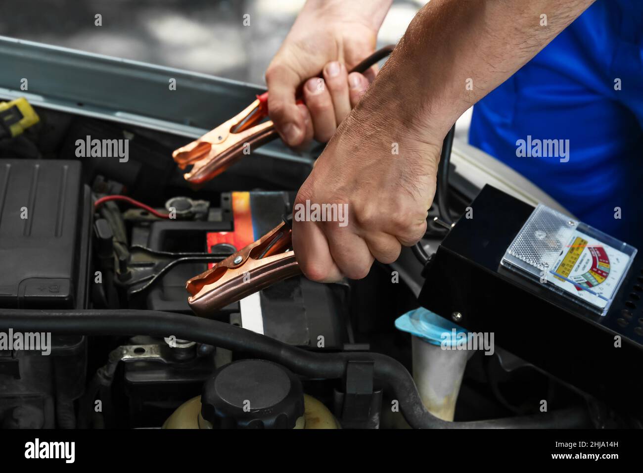 Man testing modern car battery Stock Photo - Alamy