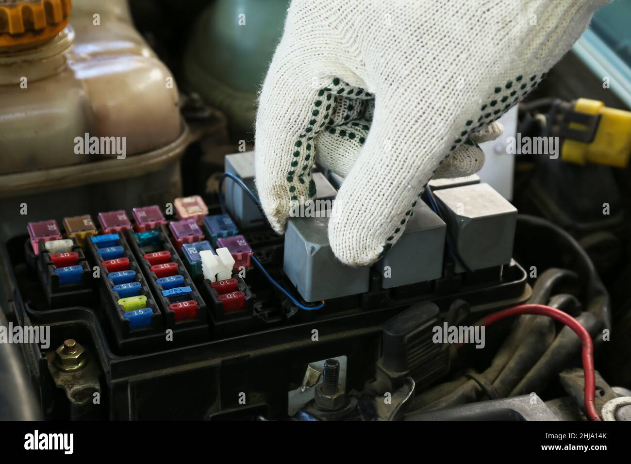Male mechanic fixing car battery Stock Photo - Alamy