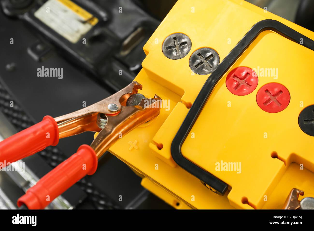 Charging of modern car battery, closeup Stock Photo - Alamy