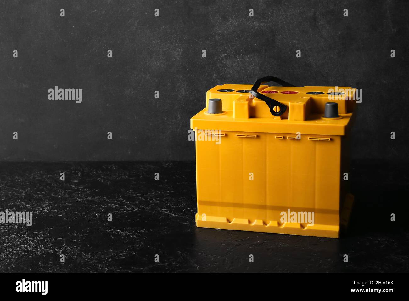 Modern car battery on black background Stock Photo - Alamy