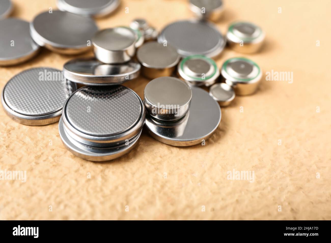 Lithium button cell batteries on beige background, closeup Stock Photo ...