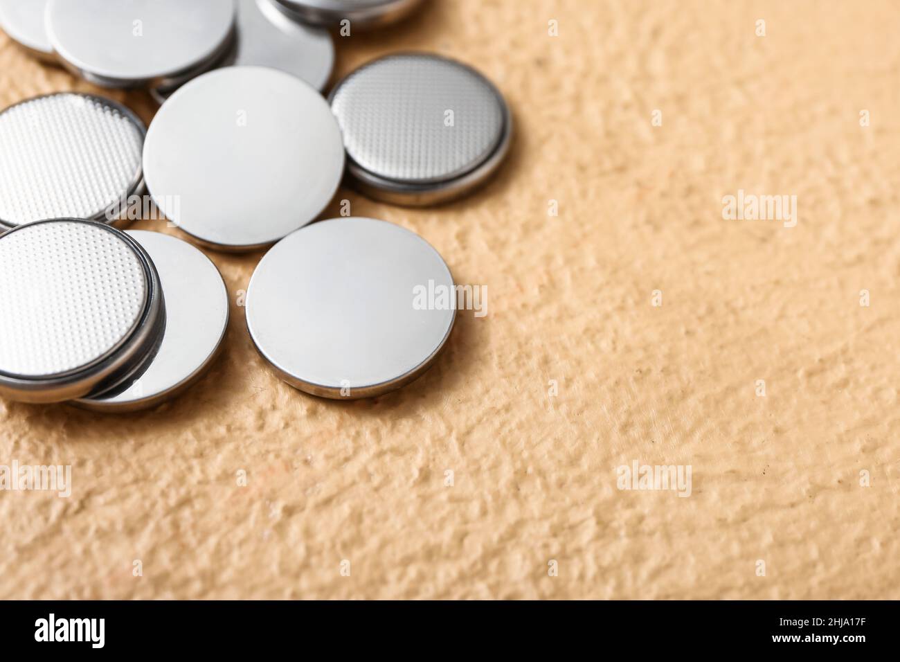 Lithium button cell batteries on beige background, closeup Stock Photo - Alamy