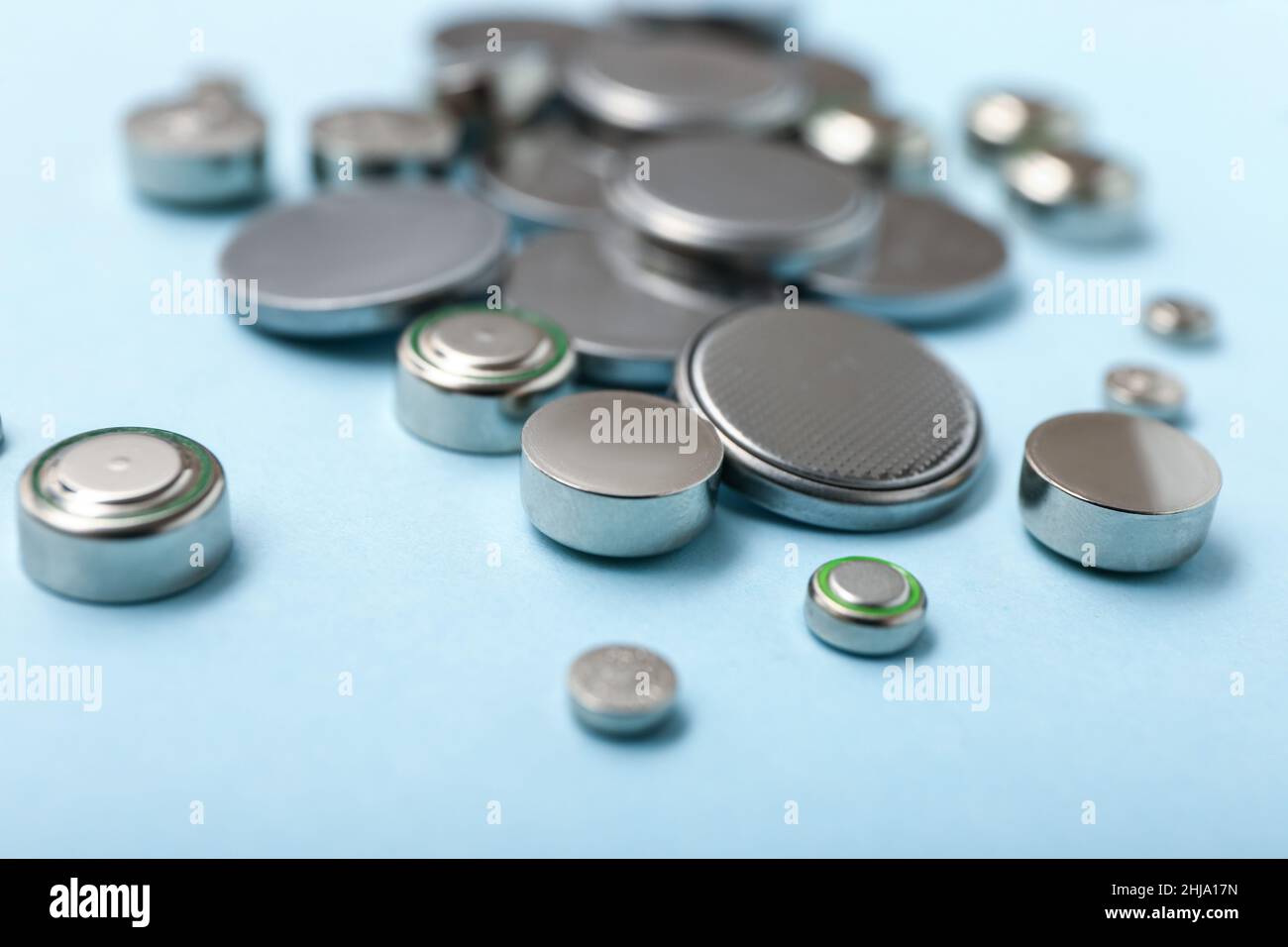 Lithium button cell batteries on blue background, closeup Stock Photo ...