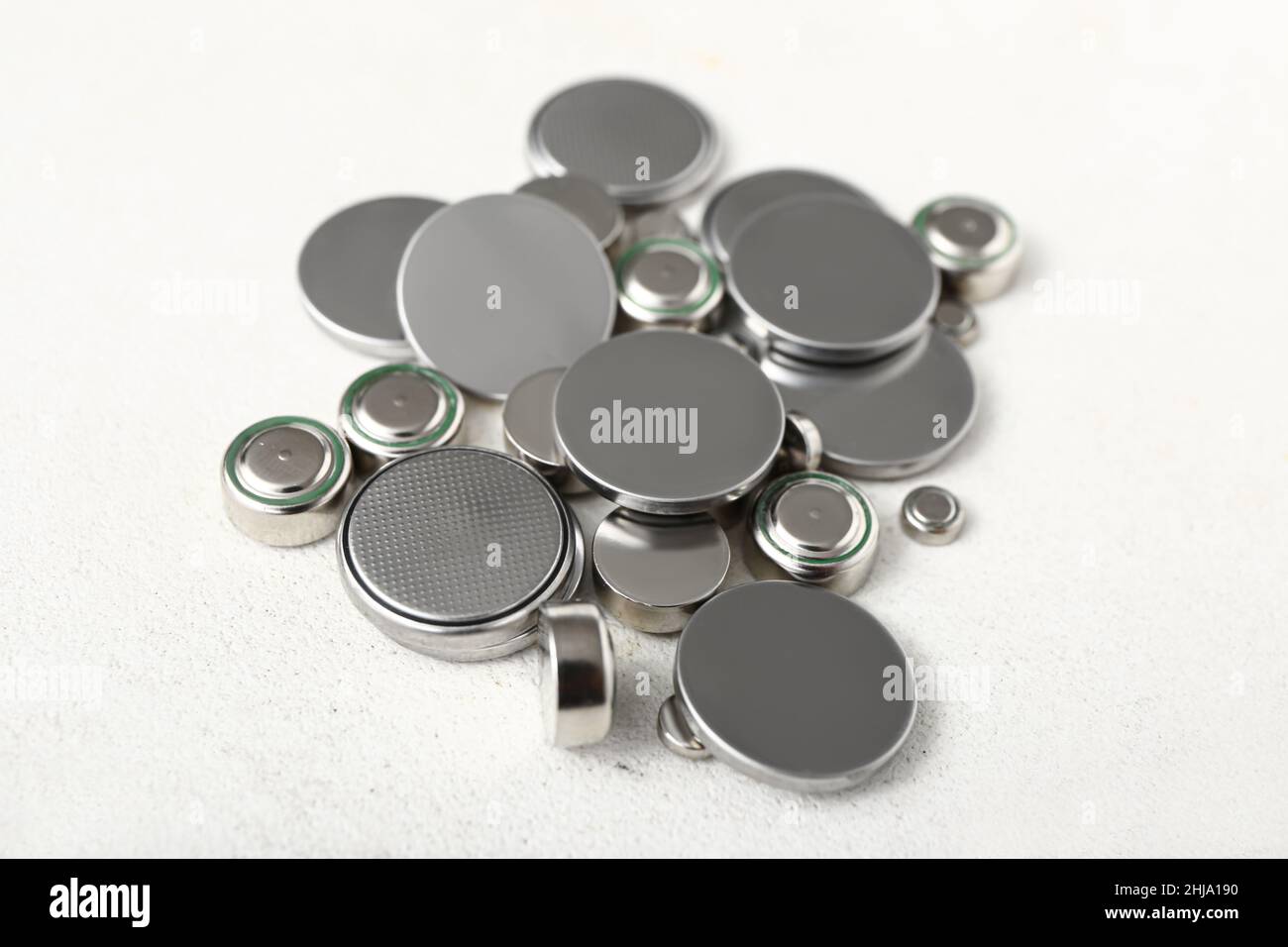 Metal lithium button cell batteries on white background Stock Photo - Alamy