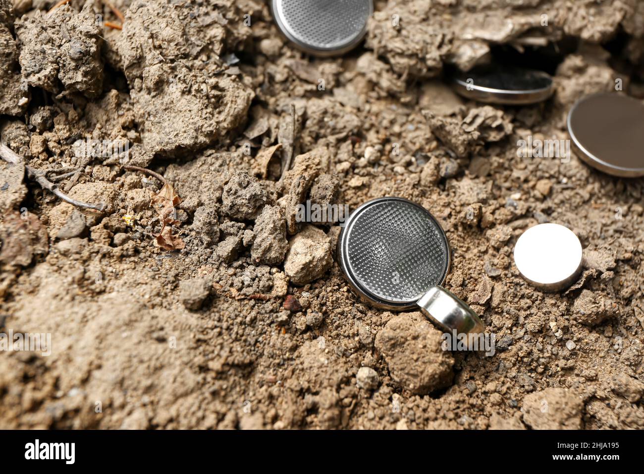Lithium button cell batteries on soil outdoors Stock Photo - Alamy