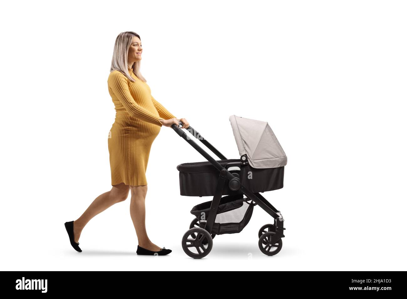 Full length profile shot of a pregnant woman walking and pushing a ...