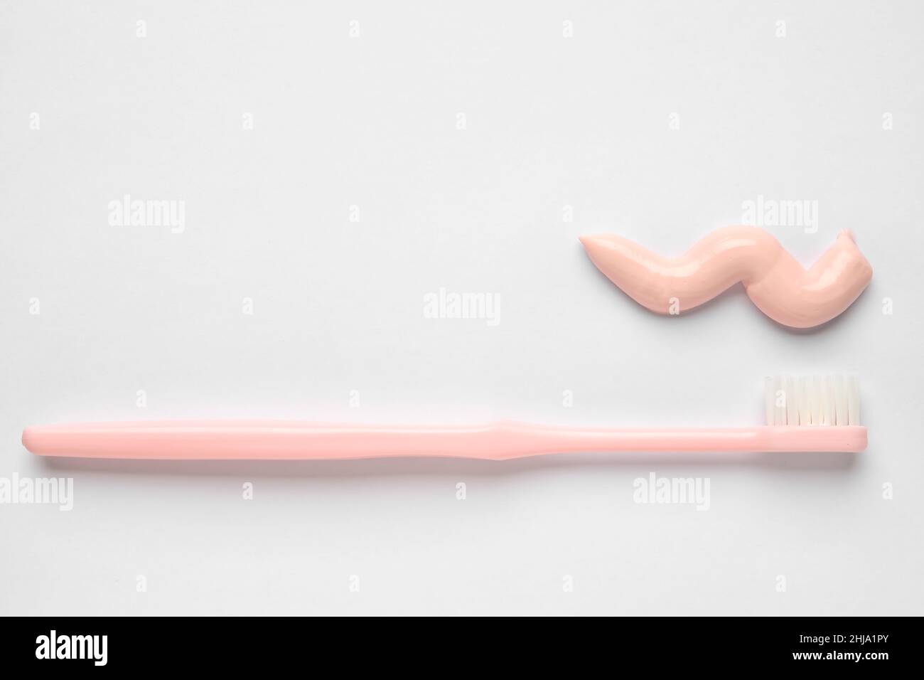 Sample of toothpaste and brush on light background Stock Photo - Alamy