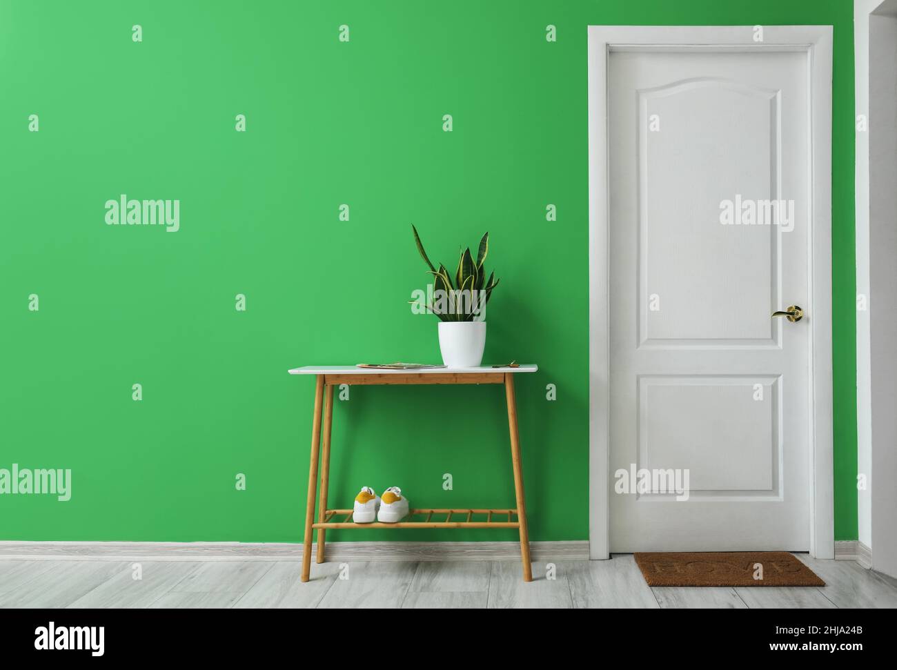 Interior of room with table near door Stock Photo - Alamy