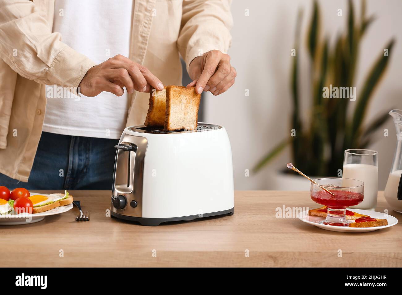 Man preparing tasty toasts hi-res stock photography and images - Alamy