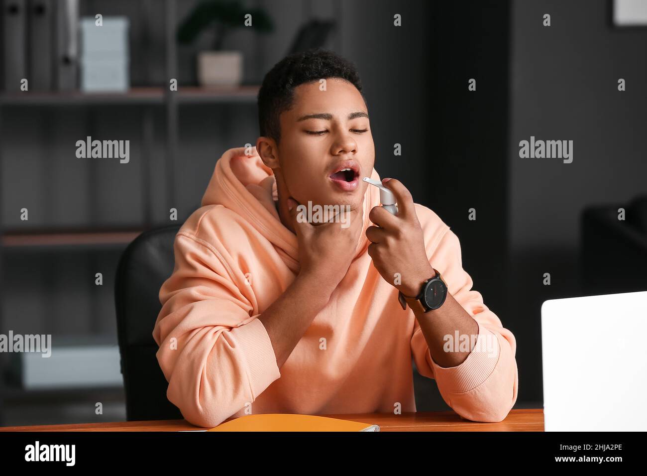 Ill African-American student with inhaler at home Stock Photo - Alamy