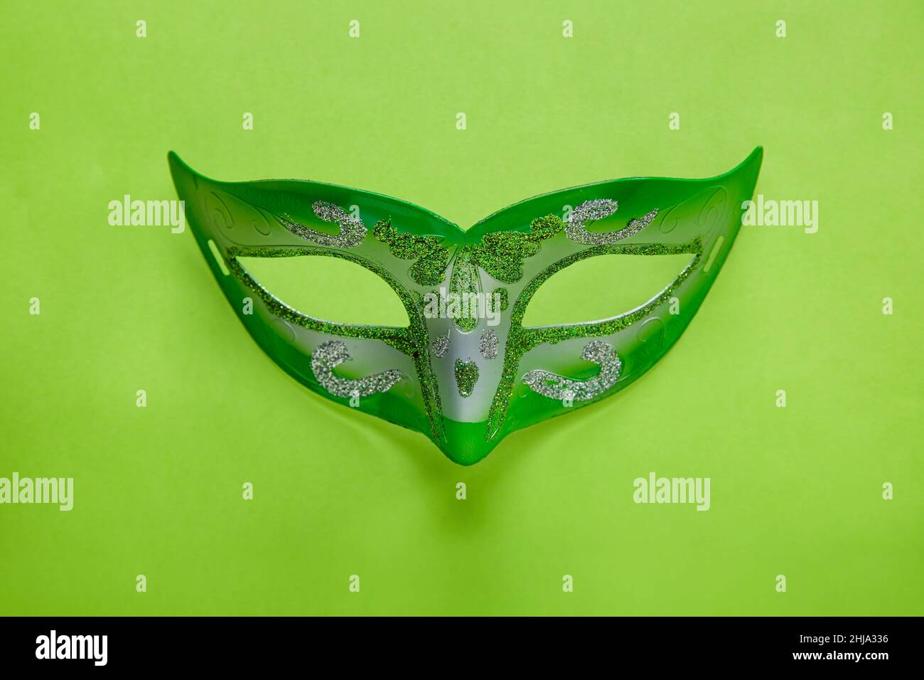 Carnival mask for Purim holiday on green background Stock Photo - Alamy