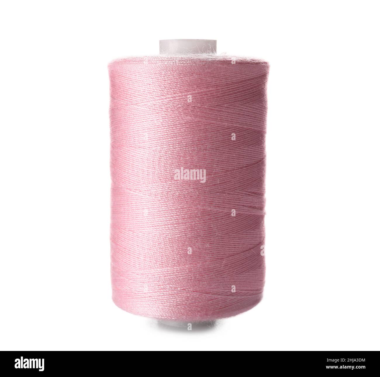 Pink sewing thread spool on white background Stock Photo - Alamy