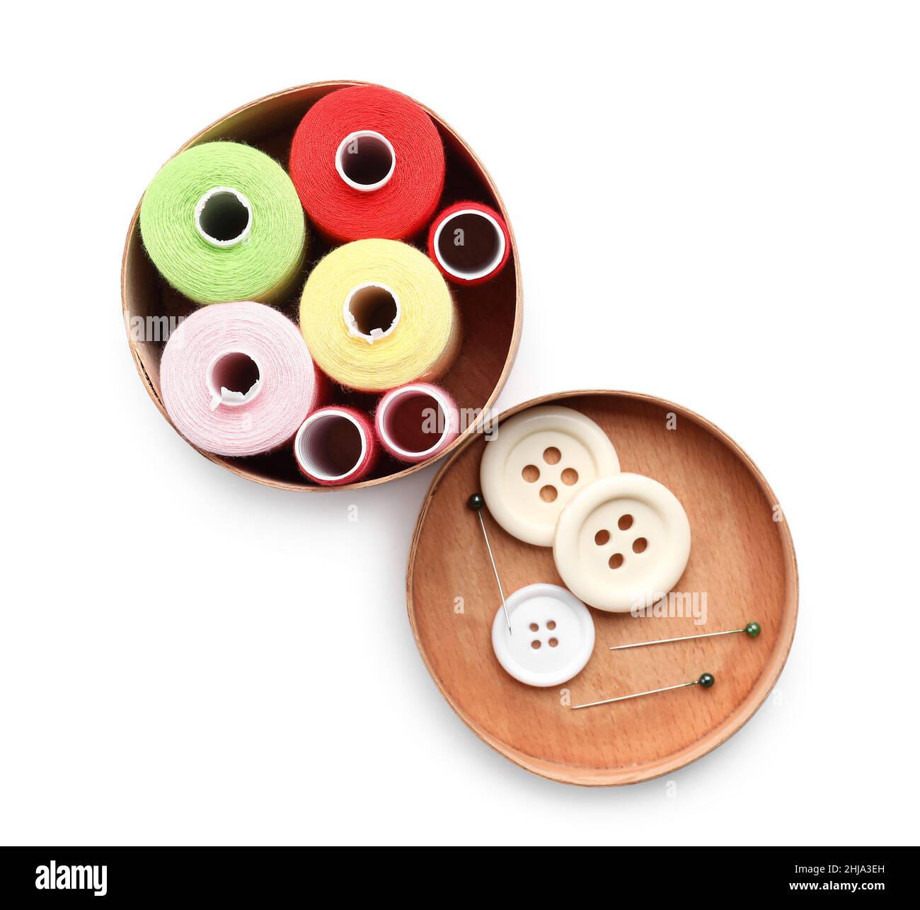 Wooden box with sewing thread spools, buttons and pins on white ...