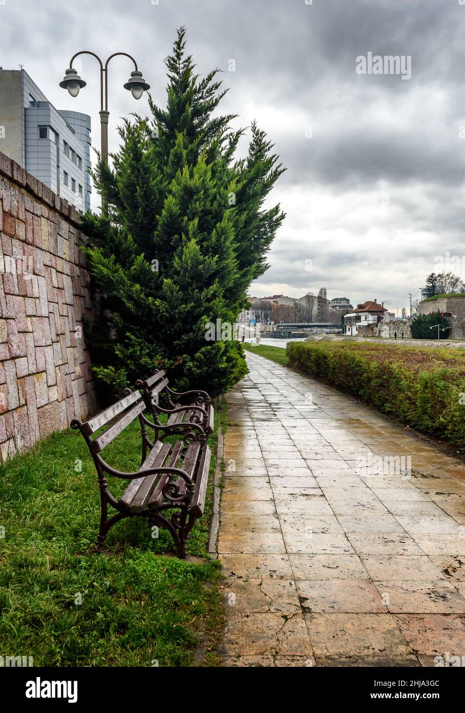 Pedestrian promenade - Paved Walkway with benches along the bank of ...