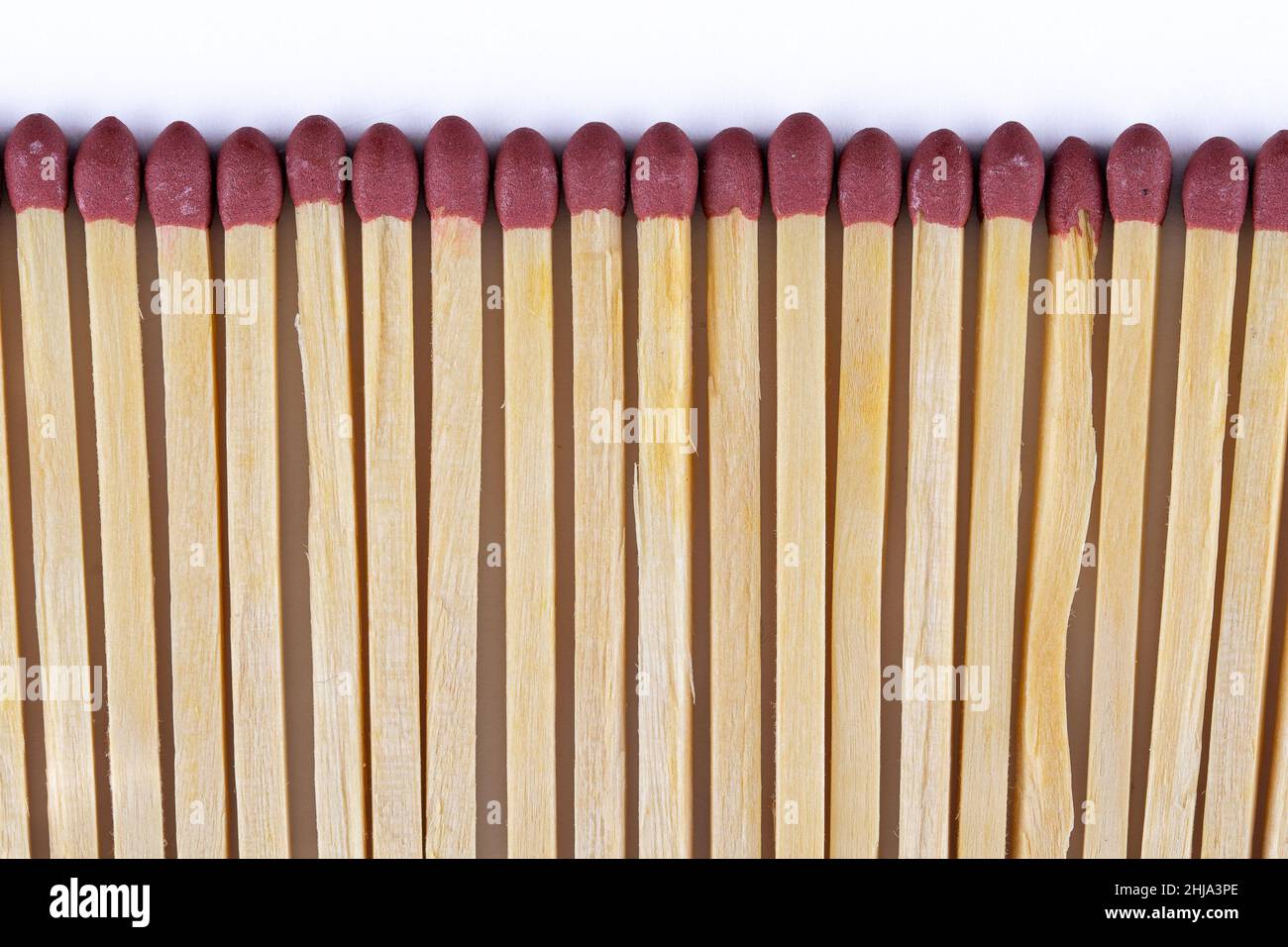Row of match sticks on a white background Stock Photo - Alamy
