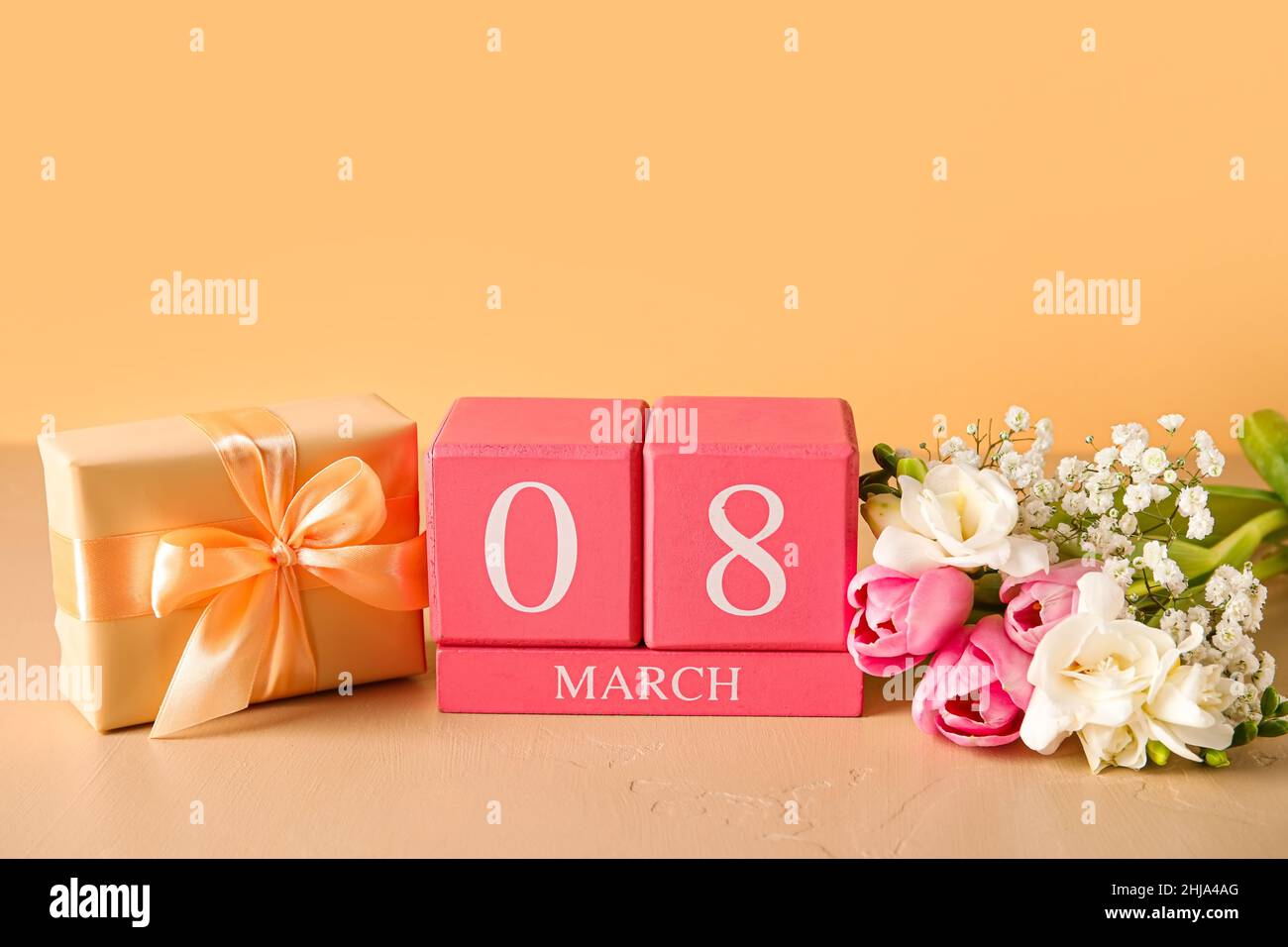 Cube calendar with date MARCH 8, gift box and bouquet of beautiful ...