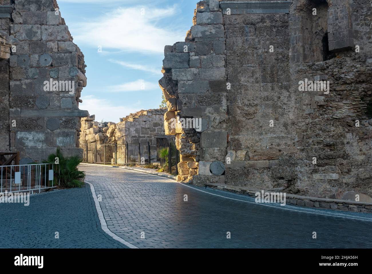 modern road passes through the ancient Vespasian Gate in Side, Turkey ...