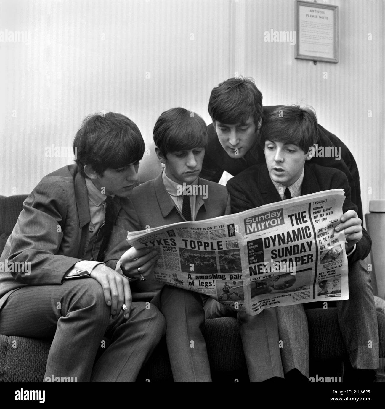 Beatles pop grouo reading the Sunday Mirror newspaper. Left to right ...