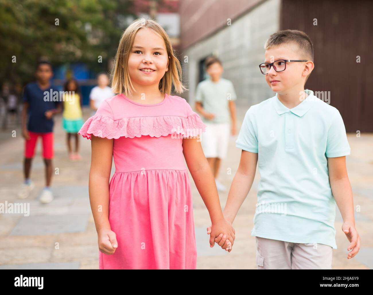 Positive boy and girl walking outdoors Stock Photo - Alamy