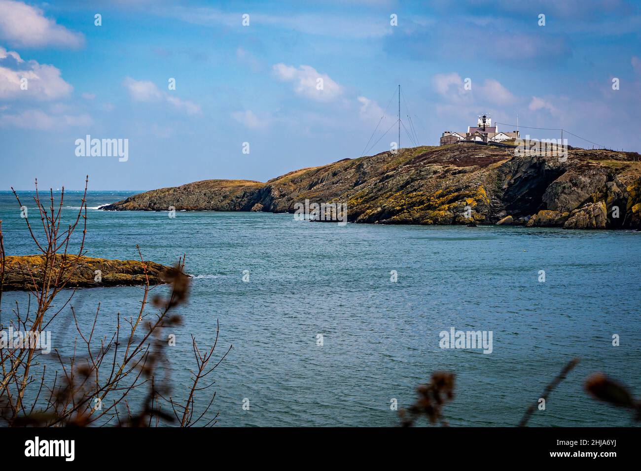 View of Point Lynas Lighthouse and Trwyn Eilian from across small Bay ...