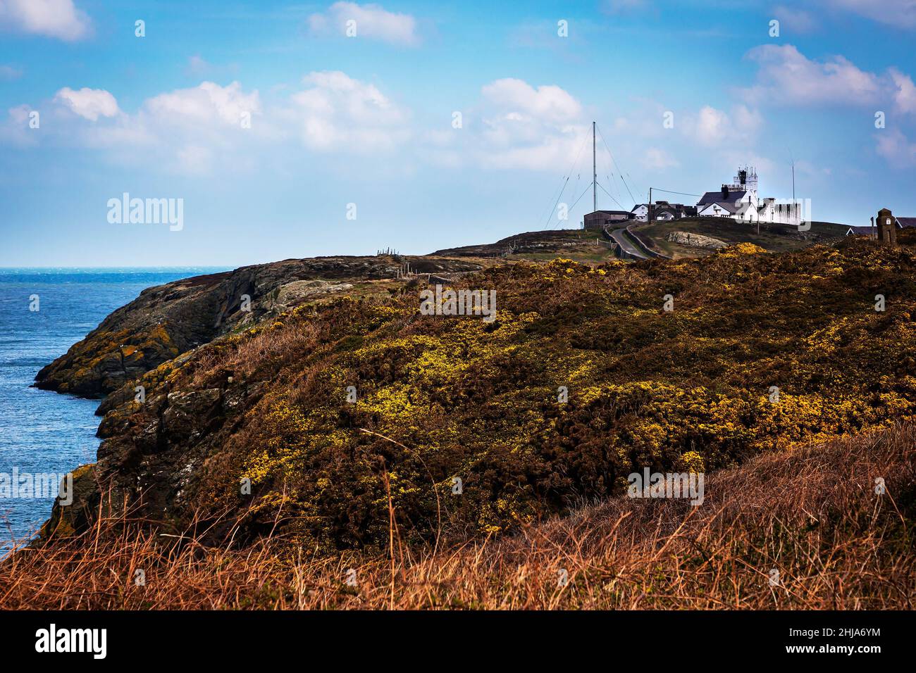View of Point Lynas Lighthouse and Trwyn Eilian from across small Bay ...