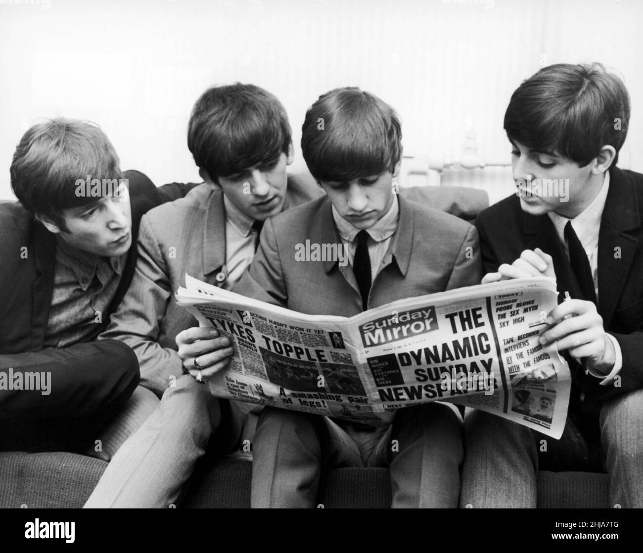 The Beatles, sit down to read the latest issue of The Sunday Mirror ...