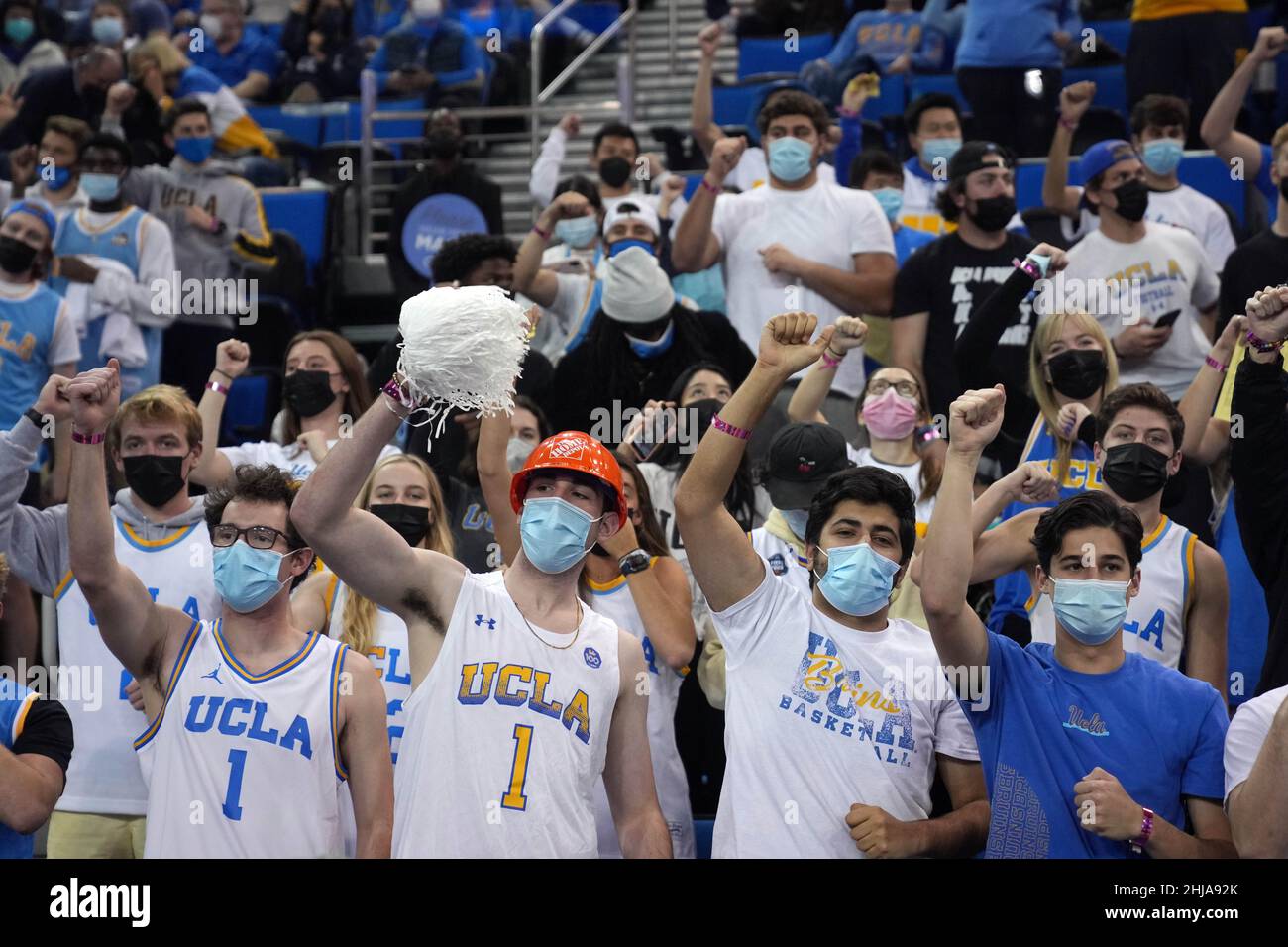 UCLA Bruins fans with face masks react during an NCAA college ...