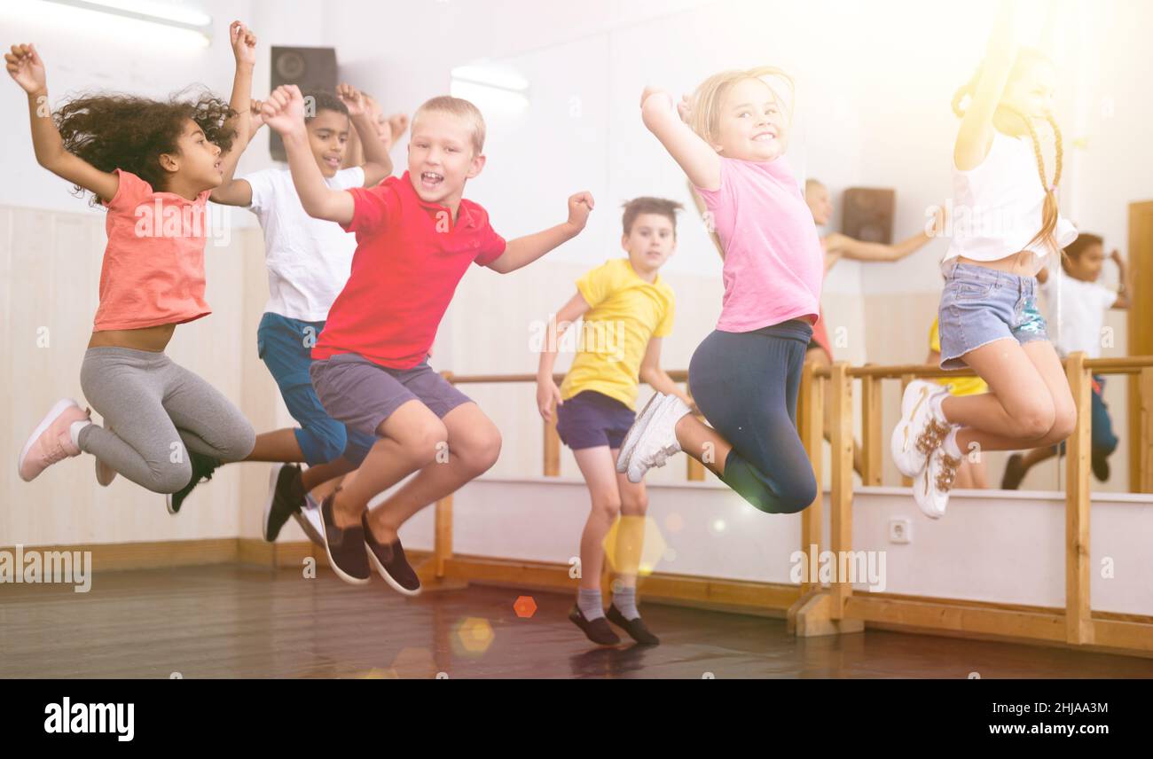 Boys and girls jumping in dance studio Stock Photo - Alamy