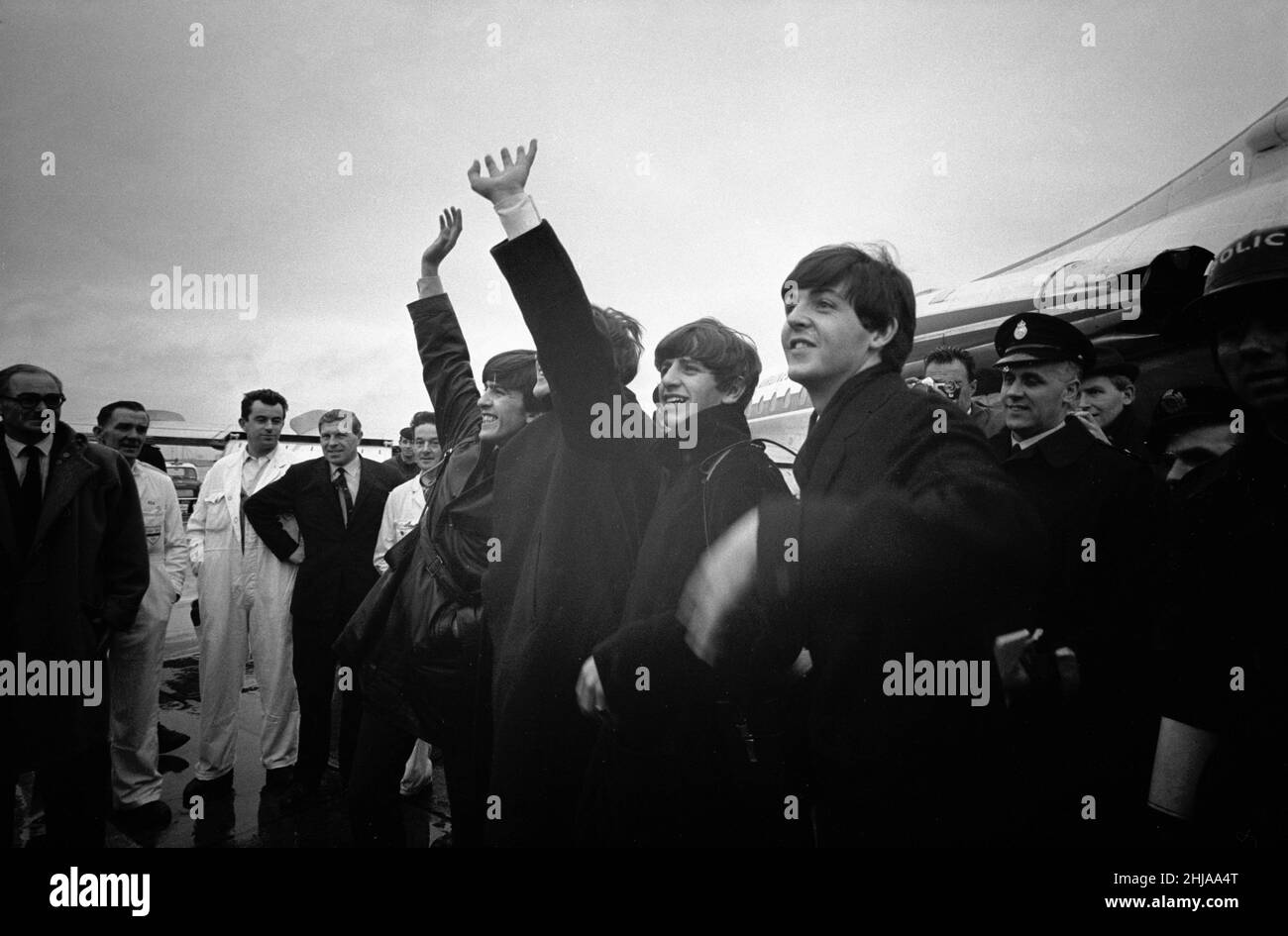 The Beatles arrive at London airport from Sweden. Surrounded by police ...
