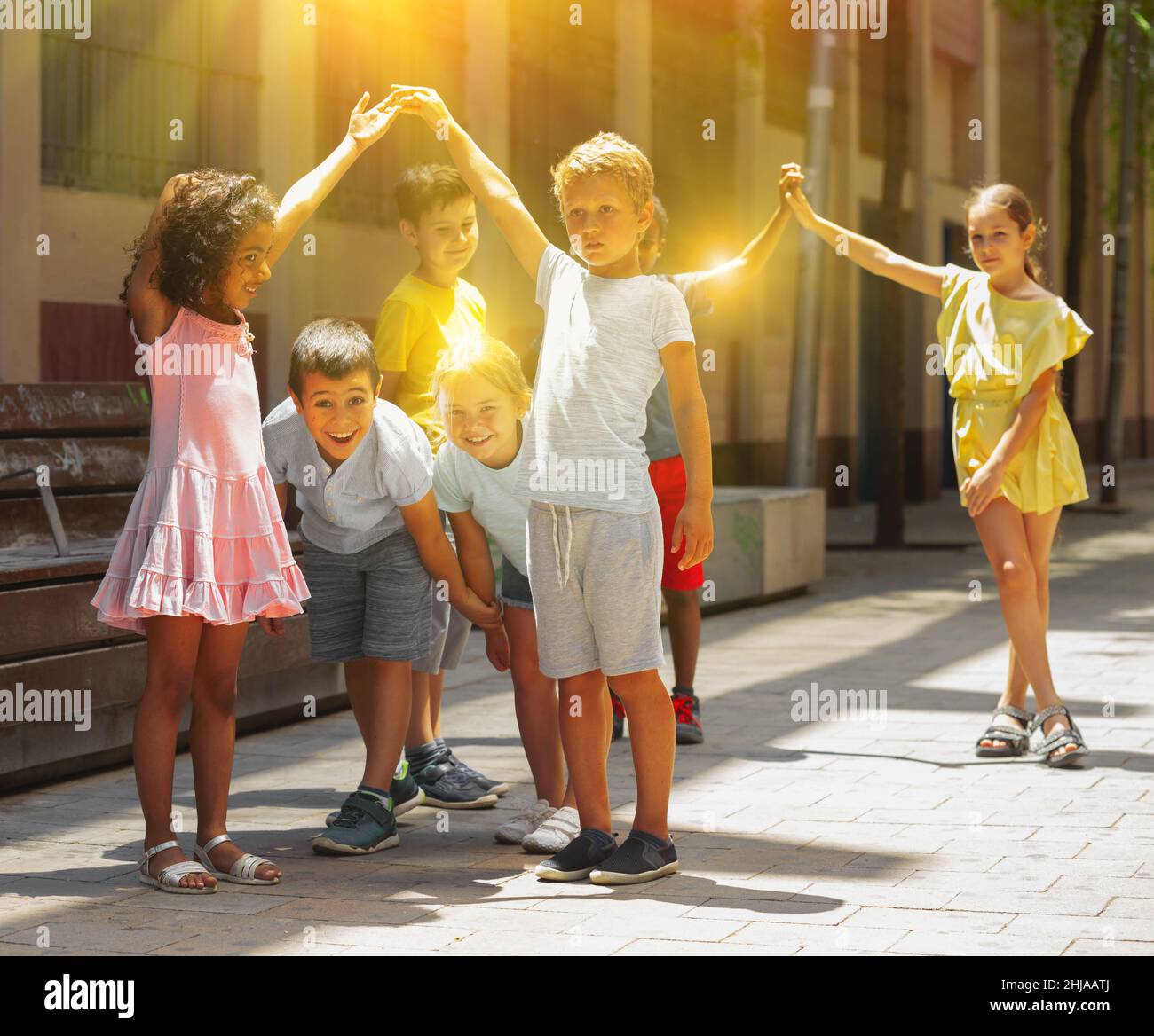 Group of happy kids playing a game called trickle on the street Stock ...
