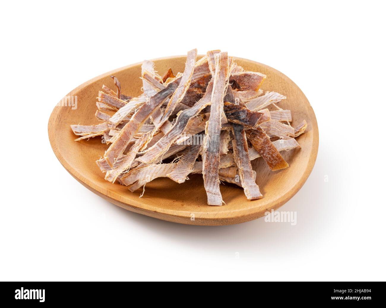 Dried squid served on a wooden plate set against a white background ...