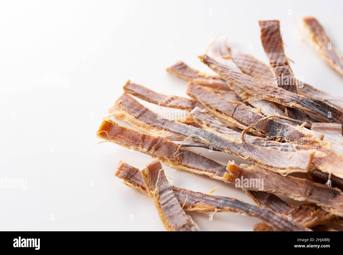 Dried squid placed on a white background. Surume is a Japanese snack ...
