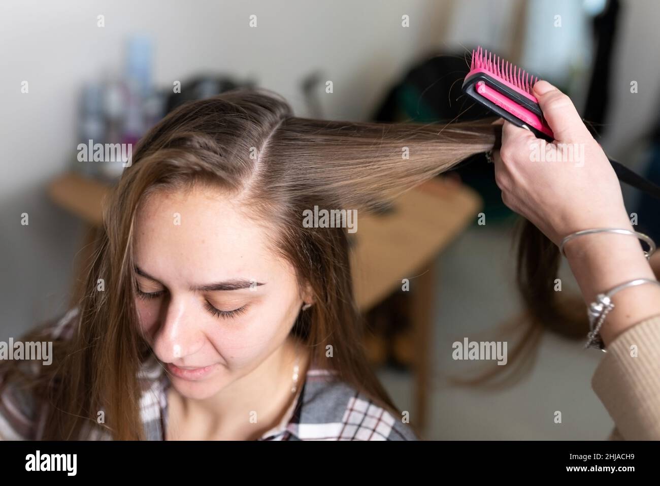 Shaping hair with a comb, parting hair Stock Photo - Alamy