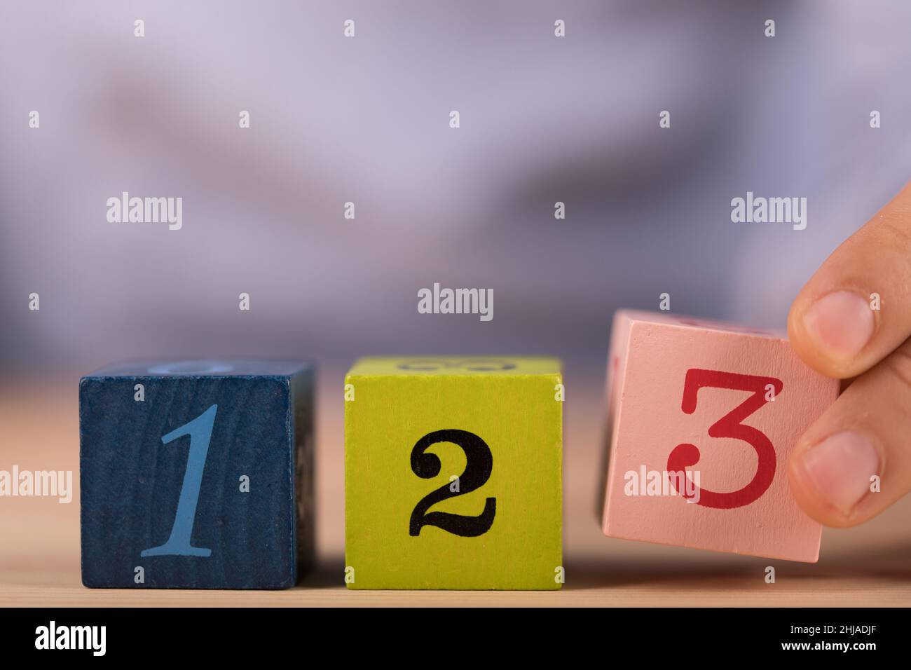 Closeup shot of a hand organizing colorful number blocks Stock Photo ...