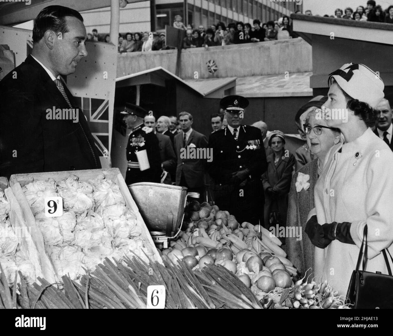 Queen Elizabeth II talks to Mr J Hand at his vegetable stall at the ...