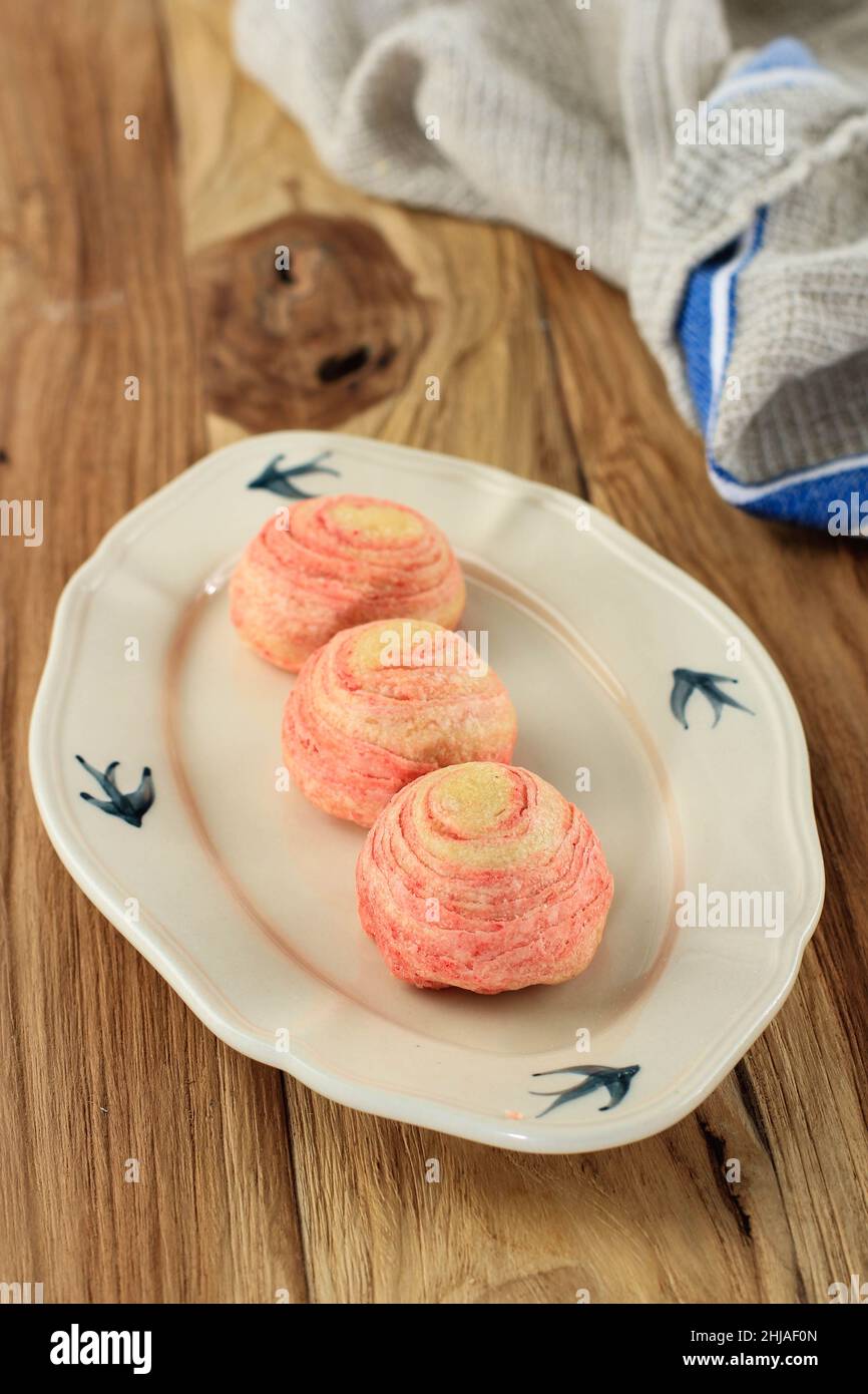 Chocolate Bakpia or Thousand Layer Mooncake on Pink Pastry Dough Stock ...