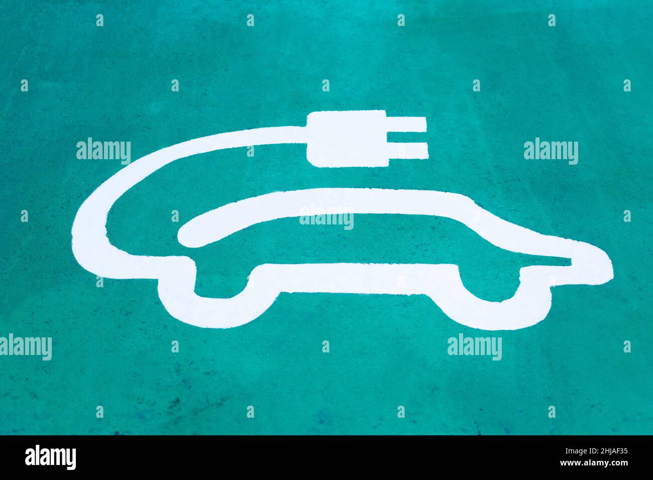 Electric cars. Sign painted on the floor of a parking lot for electric ...