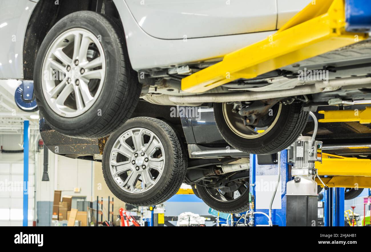 Modern Cars on Automotive Lifts In an Auto Service. Servicing Broken ...