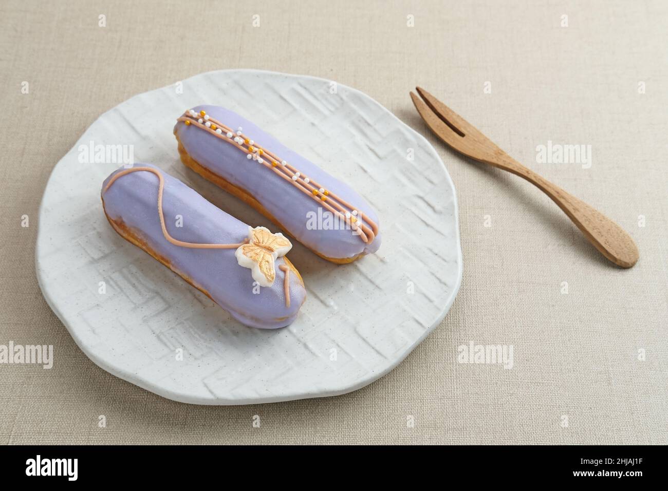 Traditional French dessert. Sweet and colorful eclairs with chocolate ...