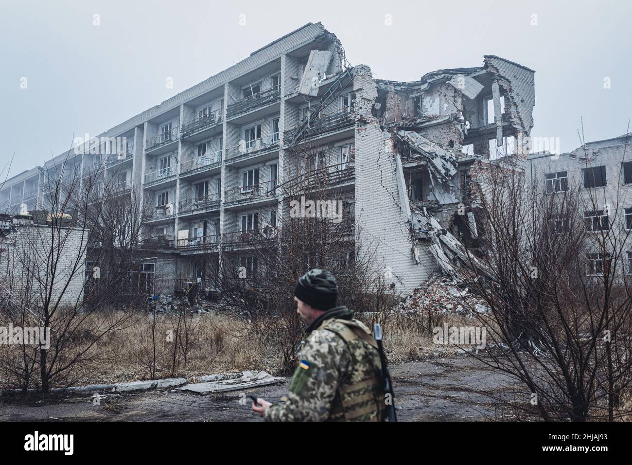 Marinka, Ukraine. 27th Feb, 2021. A soldier walks in front of a ...
