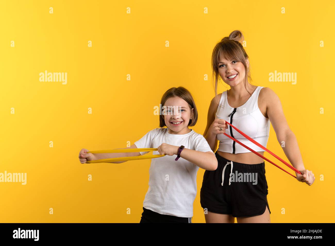 Athletic family stretching muscles after training using resistance ...