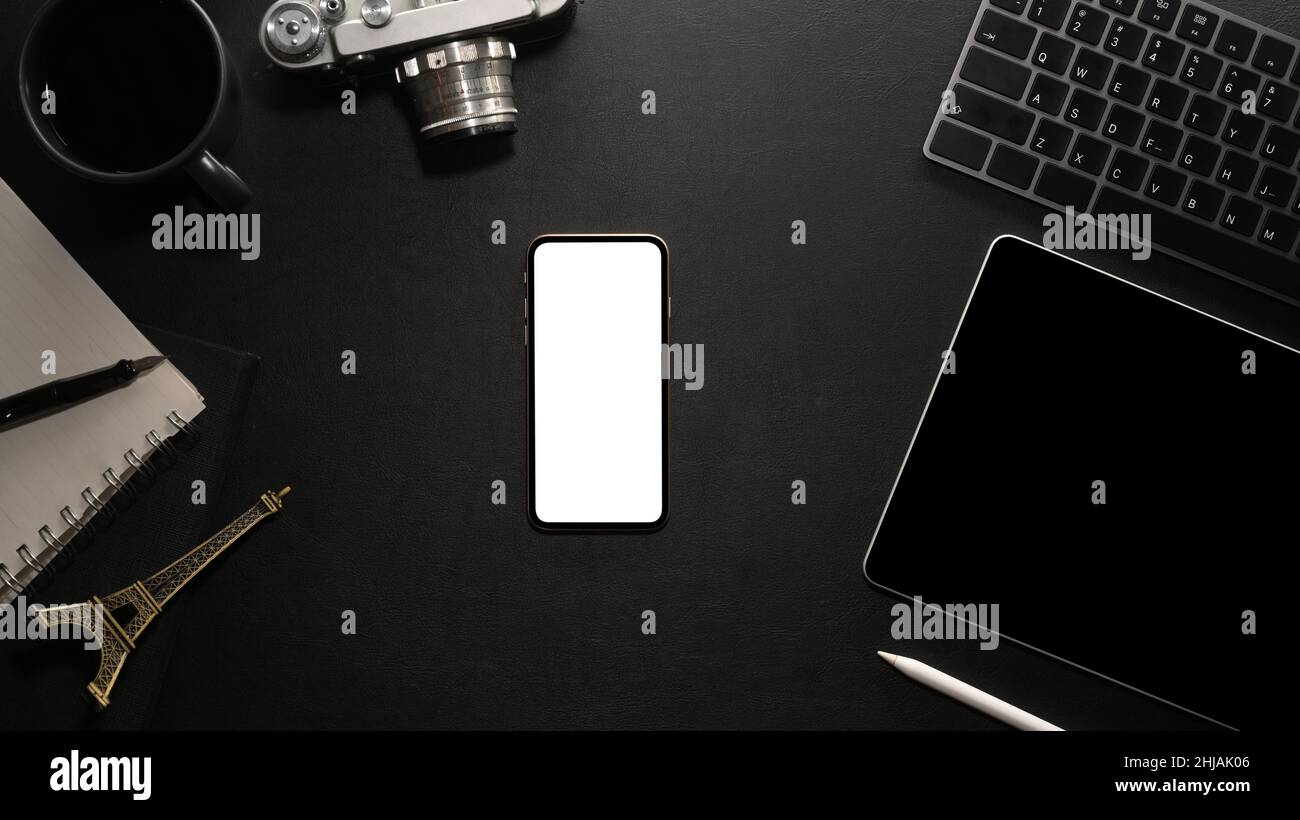 Modern black workstation top view, flat lay with smartphone blank ...