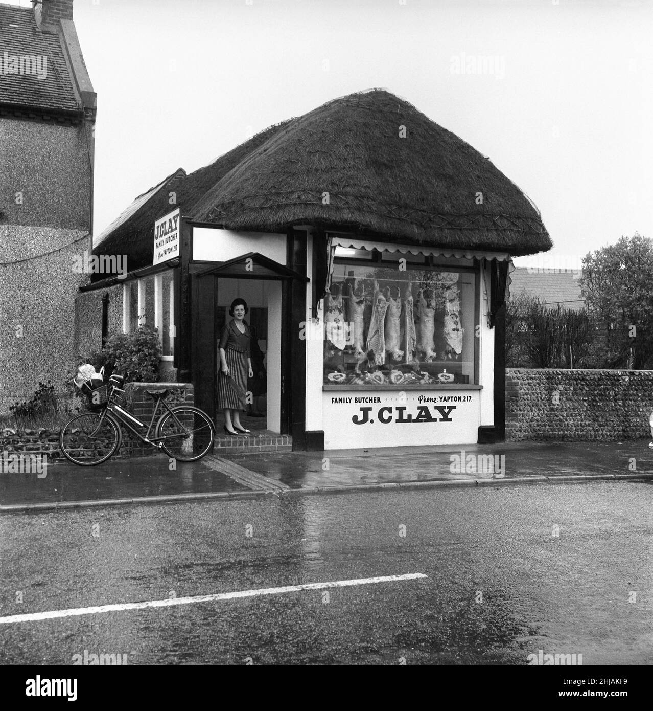 A female butcher seen here at work in her shop. Yapton, West Sussex ...