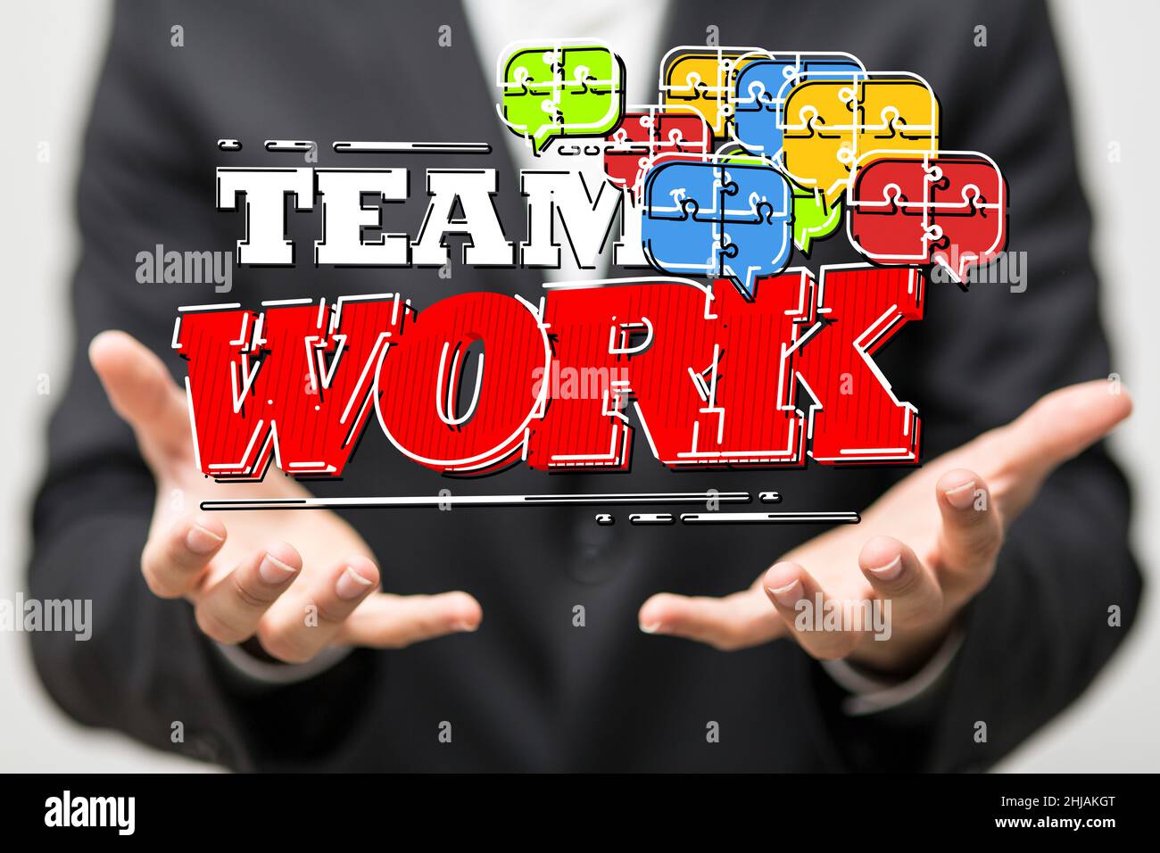 Person presenting a 3D render of Team Work sign Stock Photo - Alamy