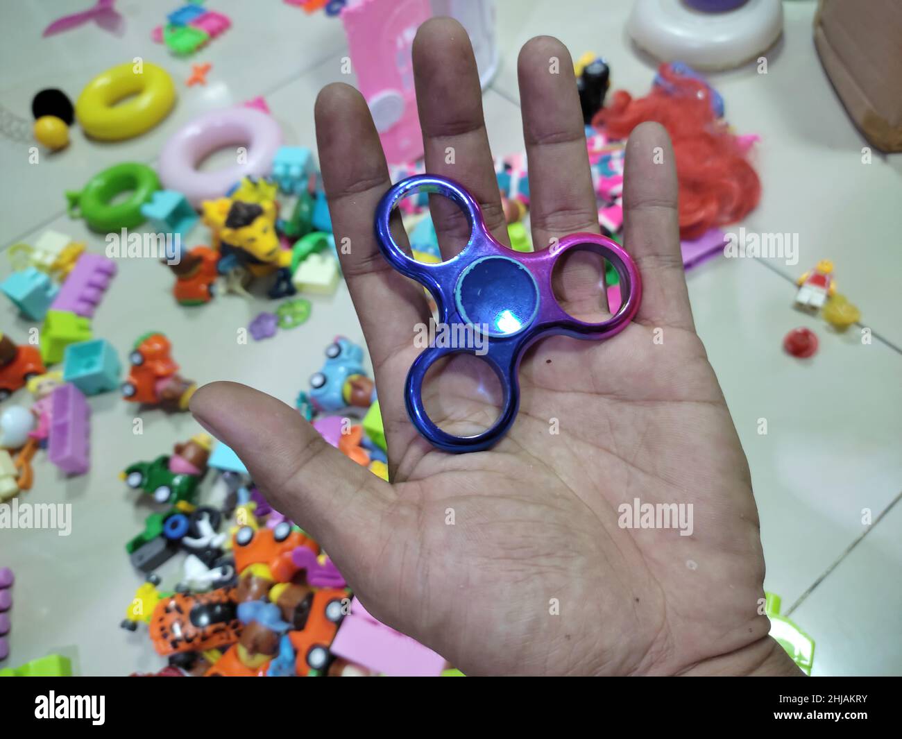 Colorful children's toys scattered on the floor Stock Photo - Alamy