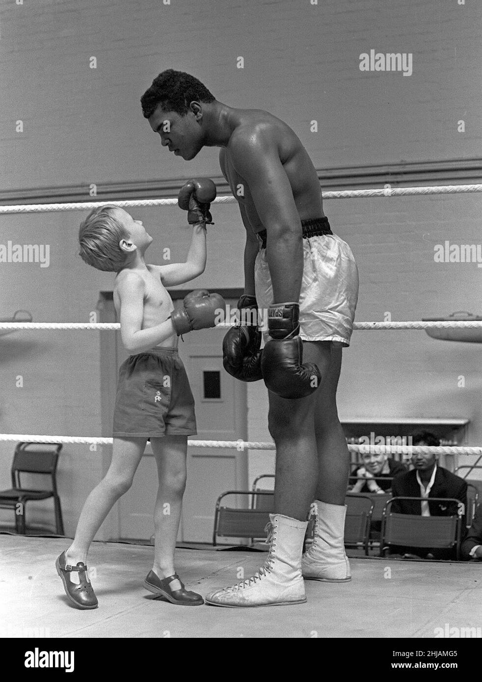Cassius Clay with 6 year old Patrick Power in the ring during his ...
