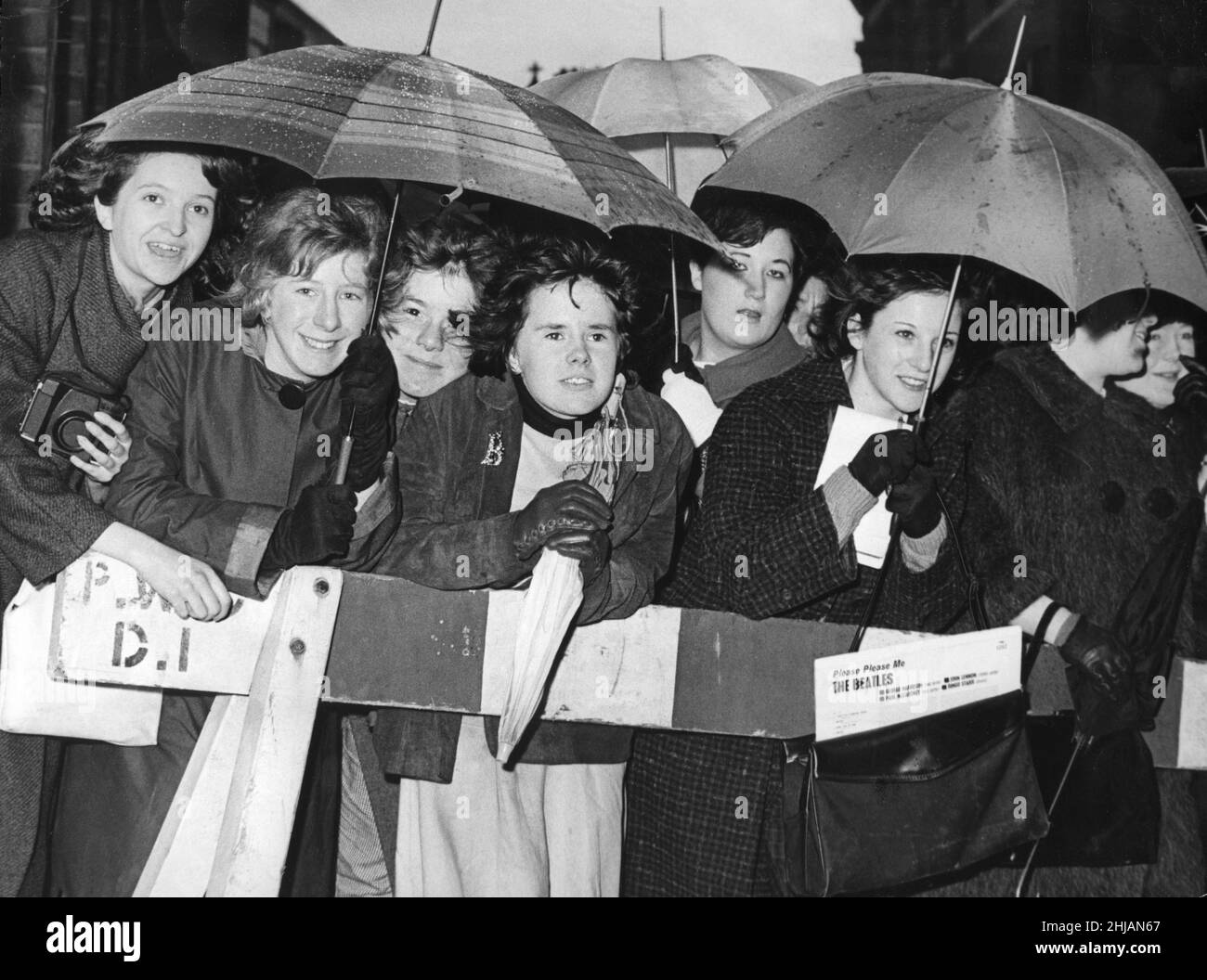 A group of girls who waited in the rain to greet their idols outside ...